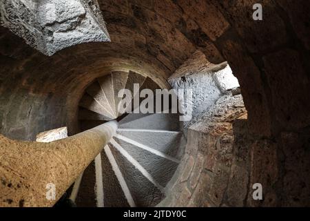 Spiral Stone Staircase Illuminated by Light Spilling through Windows ...