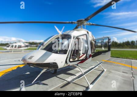 Civil white helicopter getting ready to fly take off, commercial ...
