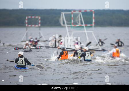 Canoe polo match, two teams play kayak polo game outdoor competition in ...
