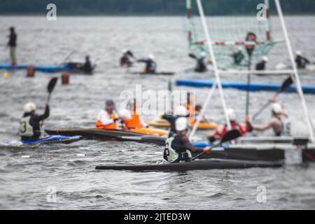 Canoe polo match, two teams play kayak polo game outdoor competition in ...