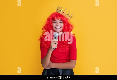 glad kid in crown with microphone and party balloon on yellow ...