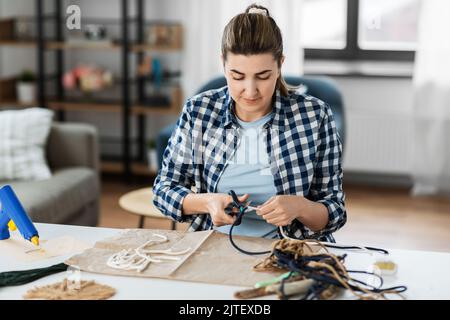 woman cutting macrame cords with scissors Stock Photo - Alamy