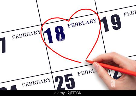 18th day of February. A woman's hand drawing a red heart shape on the ...