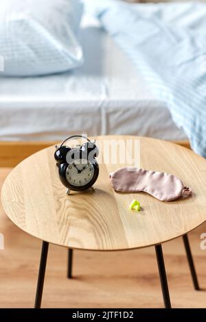 Sleeping mask with alarm clock on color background Stock Photo - Alamy