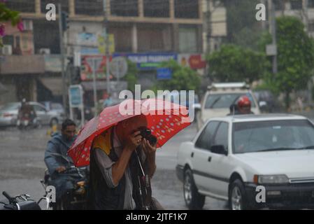 People make their way during heavy rainfall. Incessant rains for the ...