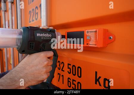 30 August 2022, Hamburg: Employee Marius Paluch attaches a live ...