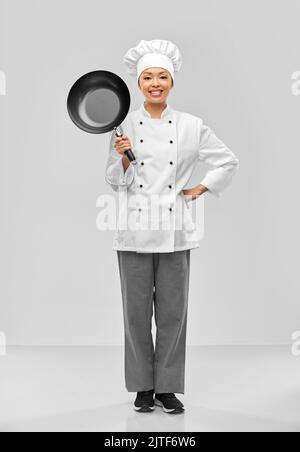 smiling female chef with frying pan Stock Photo - Alamy