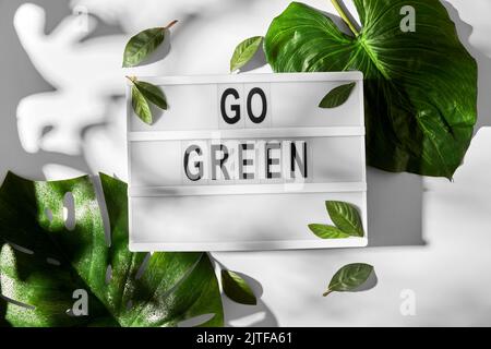 light box with go green words and leaves Stock Photo - Alamy