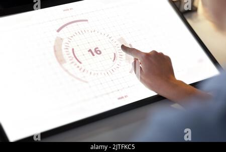 hand on led light tablet at night office Stock Photo - Alamy