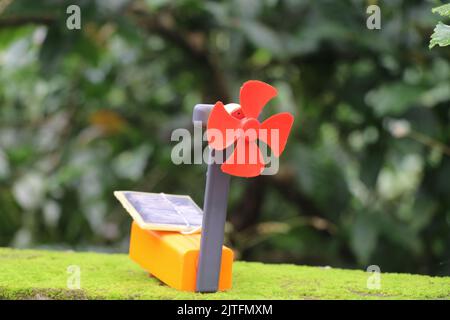 Solar cell and propeller attached to a small dc motor makes a small ...