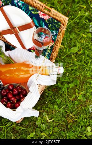 juice, cherry, book and camera in picnic basket Stock Photo - Alamy