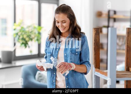 woman applying solvent to rag at home Stock Photo - Alamy