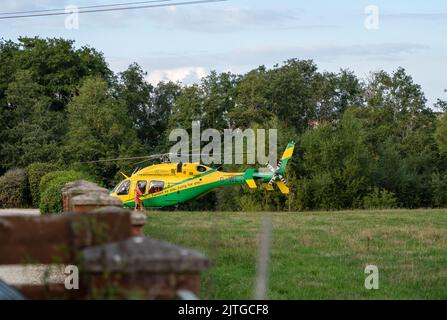 Wiltshire Air Ambulance preparing to take off from a grass field Stock ...