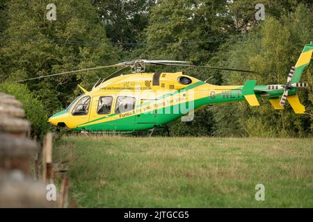 Wiltshire Air Ambulance preparing to take off from a grass field Stock ...