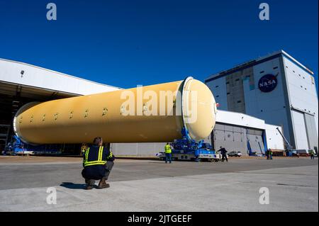 Technicians at NASA’s Michoud Assembly Facility move the engine section ...