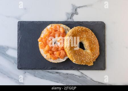 A top view of an open cut bagel with delicious meat, vegetables, and ...