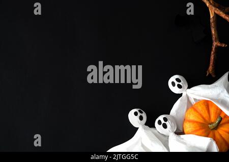 Halloween flat lay. Black ghosts and spiders on orange background ...