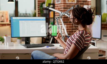 Businesswoman working remotely with greenscreen on computer, using ...