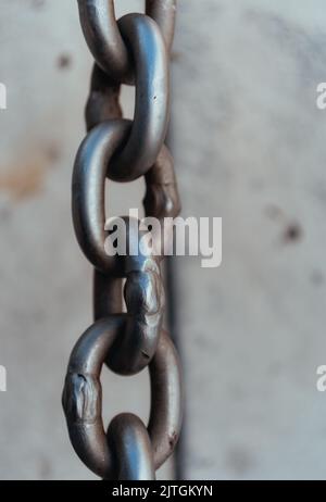 Vertical shot of rusty metal chains hanging in a hole Stock Photo - Alamy