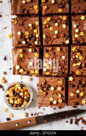 Pieces of Australian crunchie cut into squares and topped wirth milk ...