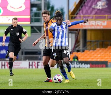 Richard Smallwood #6 of Bradford City competes for the ball with Callum ...