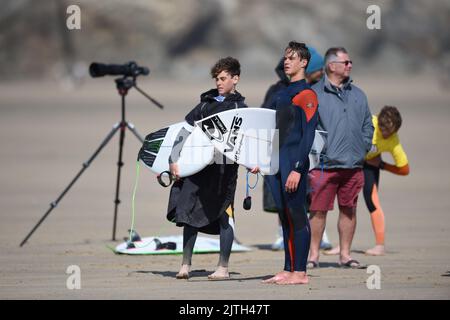 Surfers Surfing and camera on tripod Stock Photo - Alamy