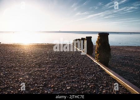 The iron pillars on the beach at sunset, vertical Stock Photo - Alamy
