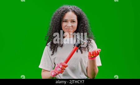 An afro female advertising plunger for toilet cleaning on a green ...
