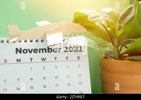 Selective focus of November 2022 desk calendar on blue background with ...
