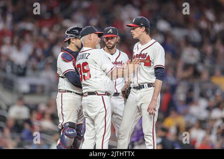 The Atlanta Braves pitching coach Rick Kranitz lights a cigar in ...