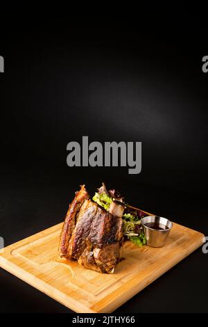 A vertical shot of a delicious big beef burger with french fries on a ...