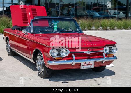 Old red Chevrolet Chevy Corvair Monza coupe 1963 in a warehouse. Front ...