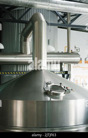 stainless steel boiler for brewing beer in a brewery. malt in the tank ...