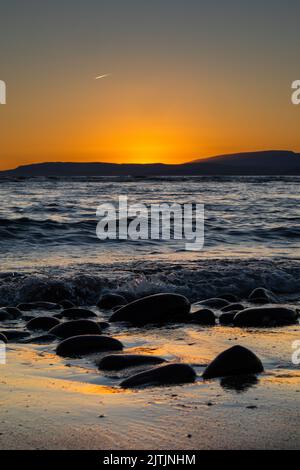 A vertical shot of the sea foam against the beautiful background of the ...