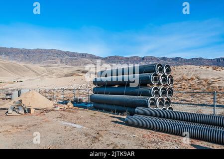 Flexible conduit or culvert pipes stacked up in an active landfill or ...