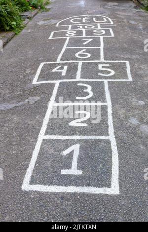 Hopscotch, fun and children playing a game together in the kitchen of ...