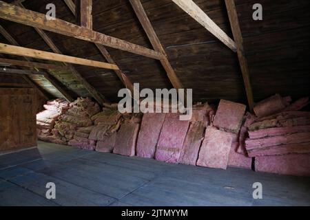 Fiberglass insulation in attic of house. Home energy savings, heating ...