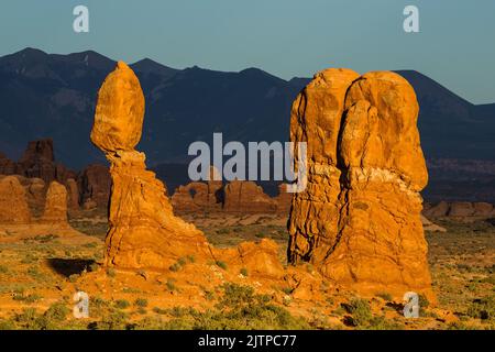 A telephoto view of Balanced Rock with Turret Arch and the La Sal ...