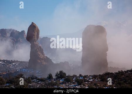 Clearing fog around Balanced Rock in winter in Arches National Park ...