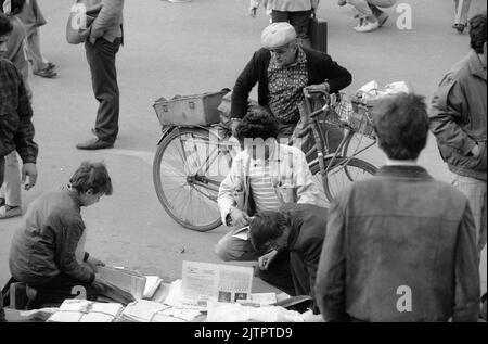 Bucharest, Romania, 1990. People looking to buy newspapers from a ...