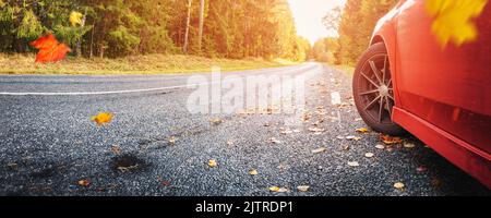 Red car on the autu asphalt road in countryside Stock Photo - Alamy