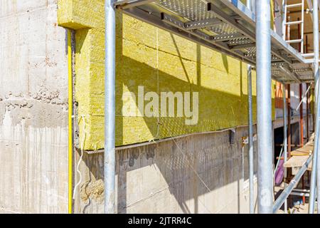 Applying thermal isolation stone wool on the brick wall of residential ...