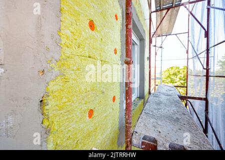 Applied thermal isolation stone wool on the brick wall of residential ...