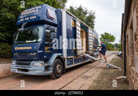 Man packing and moving house with Broughton Removals lorry container ...