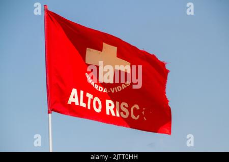 red signal flag written in portuguese "high risk" on copacabana beach ...