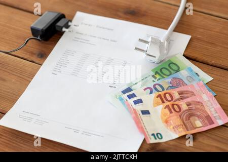 utility bill, money and electric plugs on table Stock Photo - Alamy