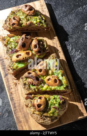Halloween spooky pizza bread with skull-shaped mushroom Stock Photo - Alamy