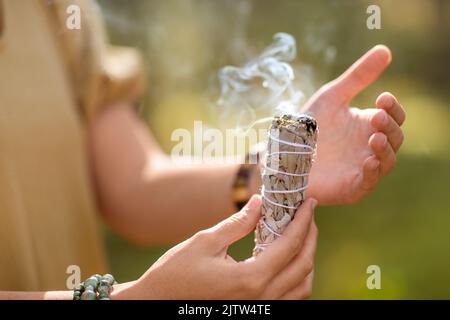 woman with sage performing magic ritual in forest Stock Photo - Alamy