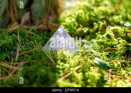 quartz crystal pyramid on moss in forest Stock Photo - Alamy