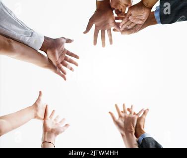 Teamwork and success go hand in hand. High angle shot of a group of ...